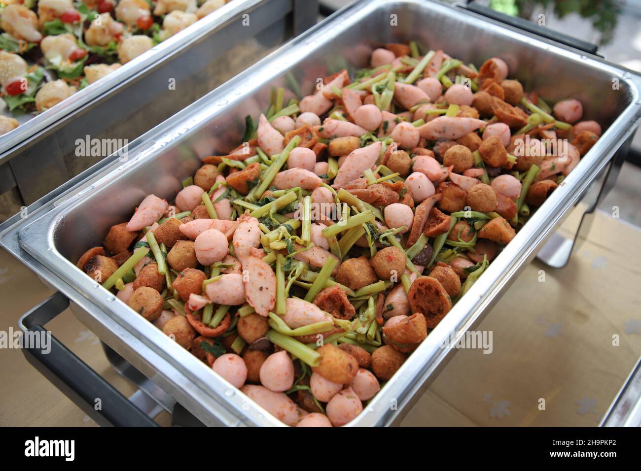 Spicy stir fried with meatballs and morning glory in buffet line. The ...
