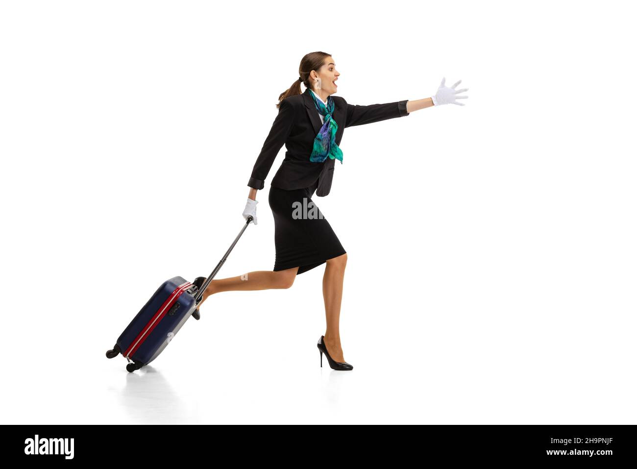 Full-length portrait of beautiful young woman, flight attendant running ...