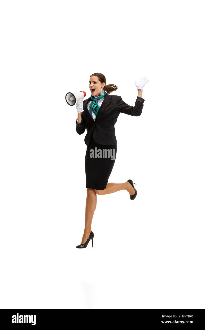 Portrait of beautiful young woman, flight attendant jumping with ...