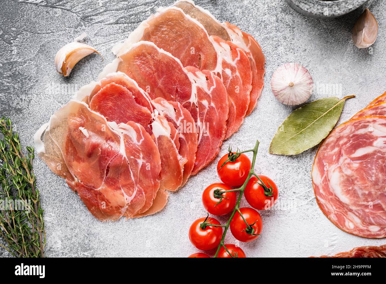 Prosciutto crudo, italian salami, parma ham set, on gray stone table ...