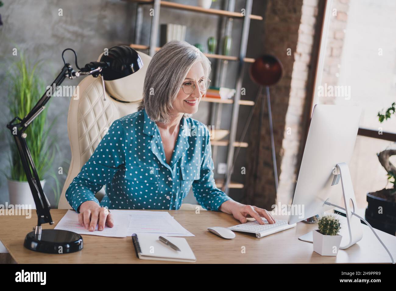 Photo of happy charming old woman business lady look computer smile ...