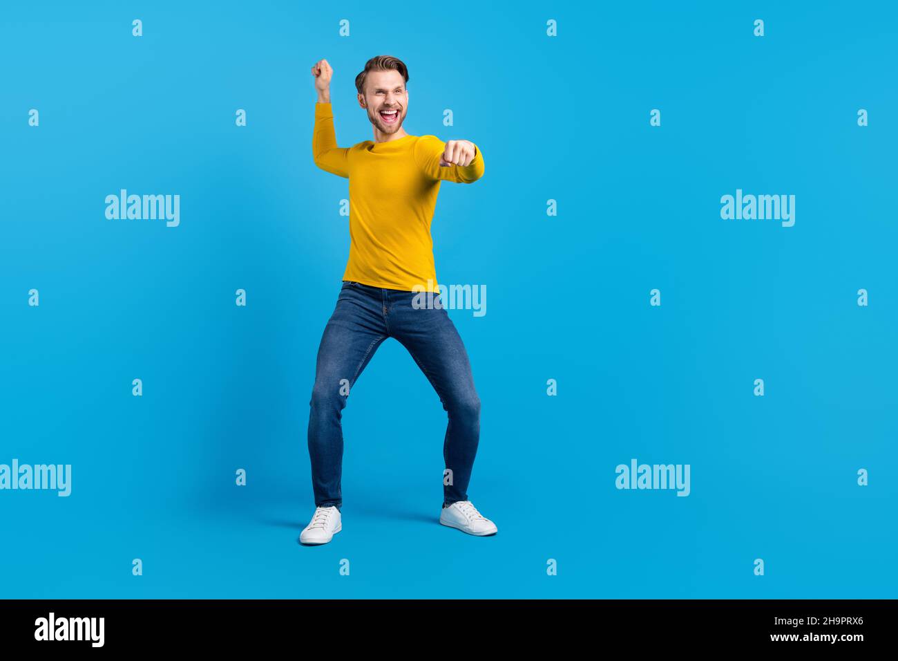 Full length body size photo of smiling man playful imagine riding horse ...