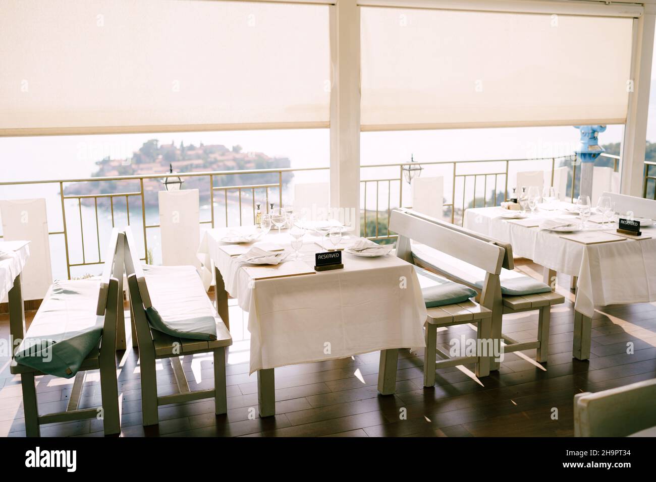 Restaurant with long benches and tables covered with tablecloths ...