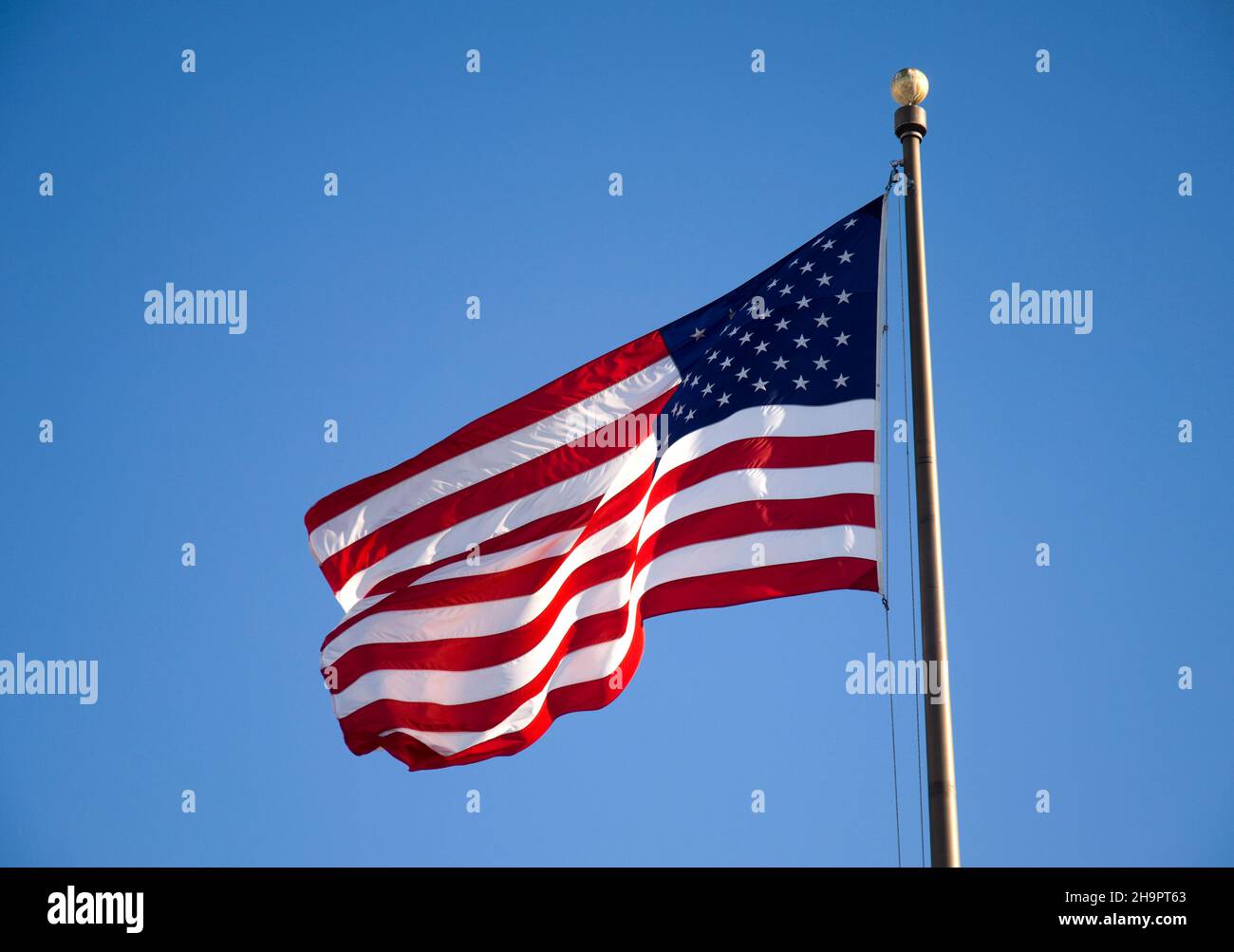 American flag against a pure blue sky Stock Photo - Alamy