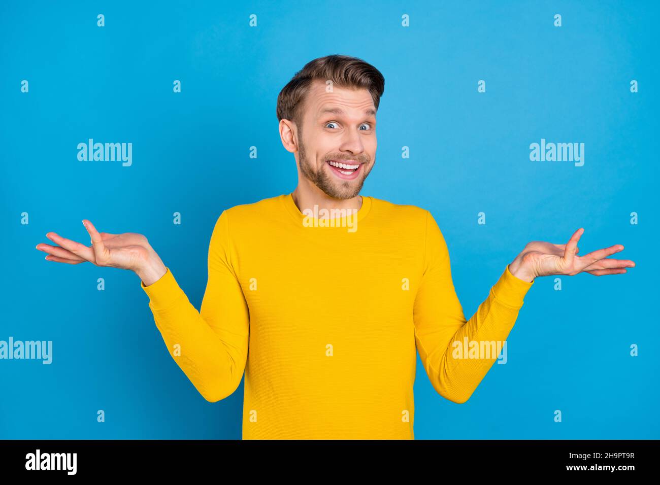Photo of young cheerful man happy positive smile shrug shoulders ...