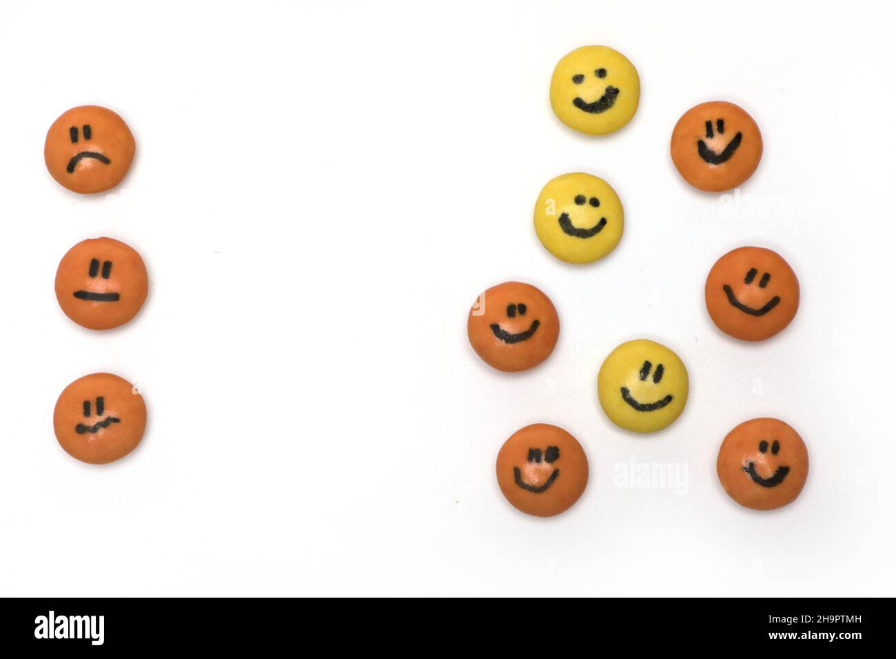 two groups of round candy with faces on them representing from sad to ...