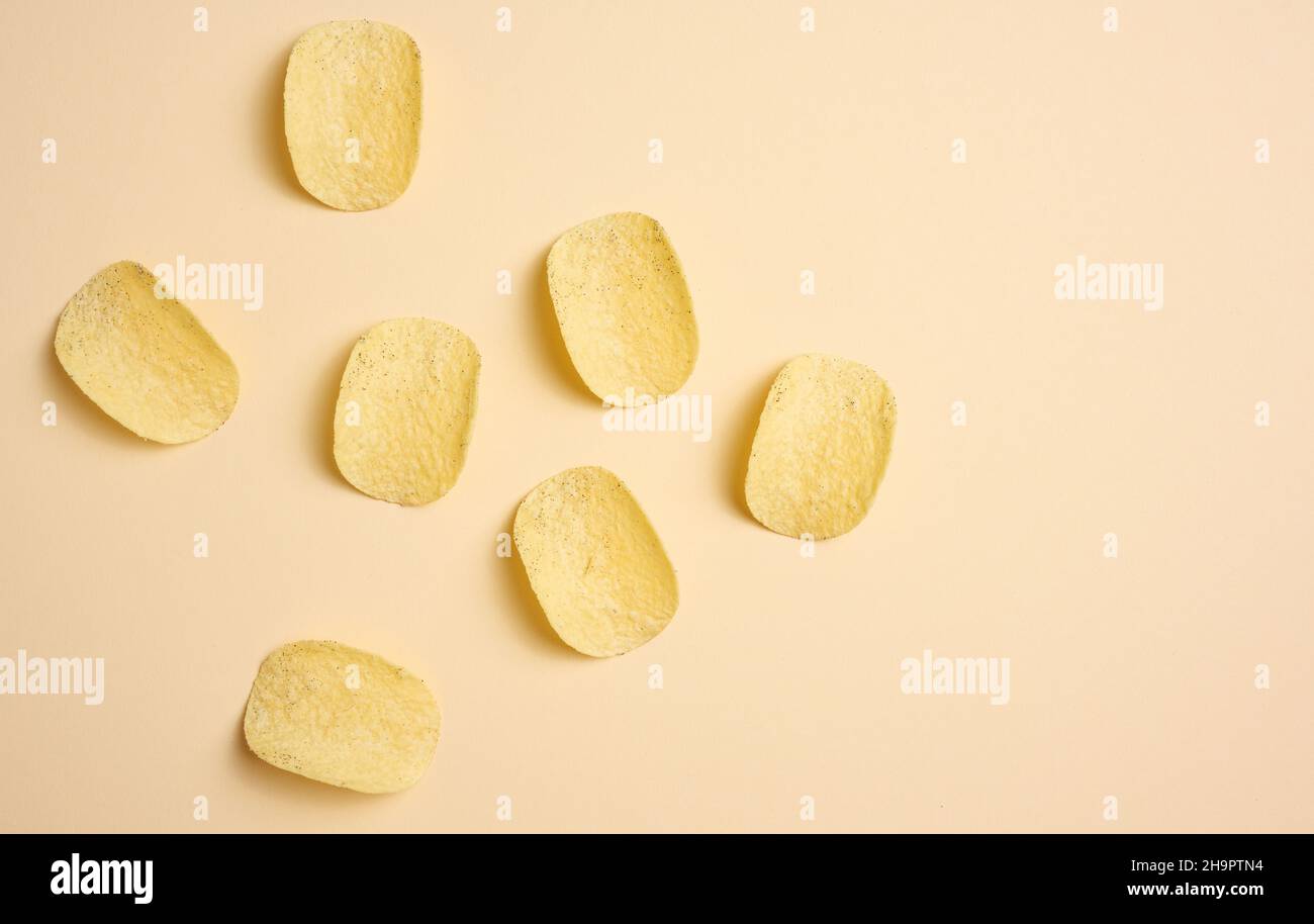 round potato chips on a beige background, top view Stock Photo - Alamy
