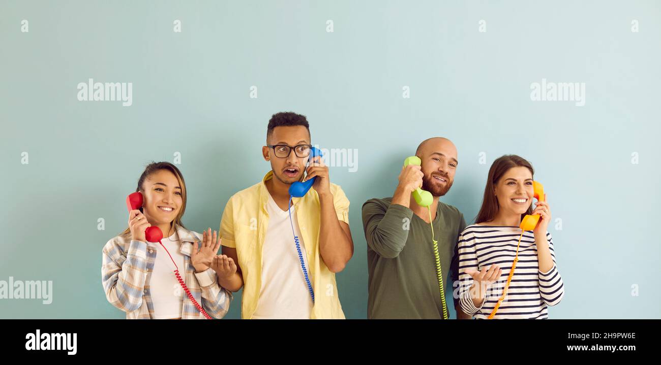 Diverse group of happy young people calling their friends and sharing ...