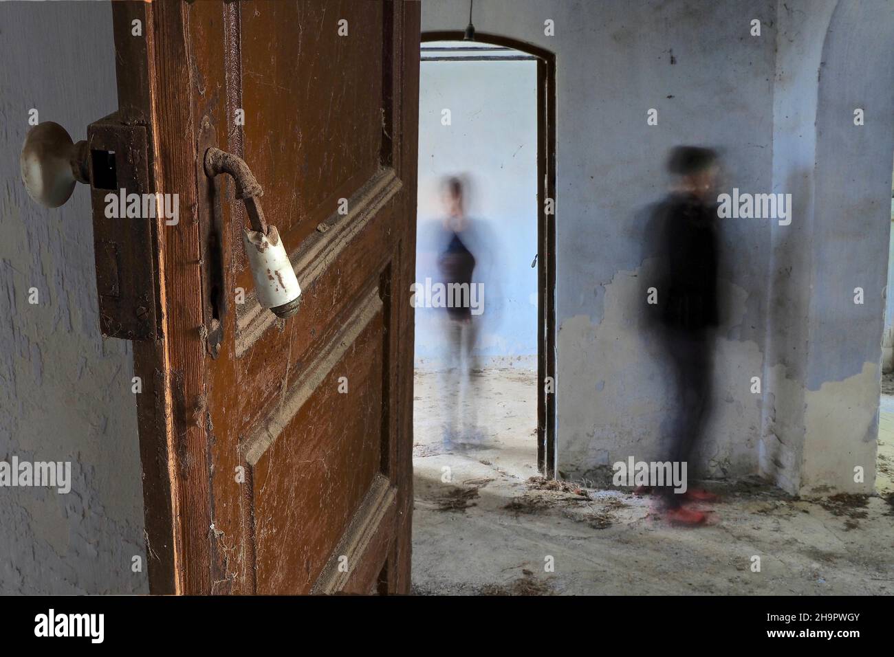 Open door with two people in abandoned house, lost place, empty flat ...