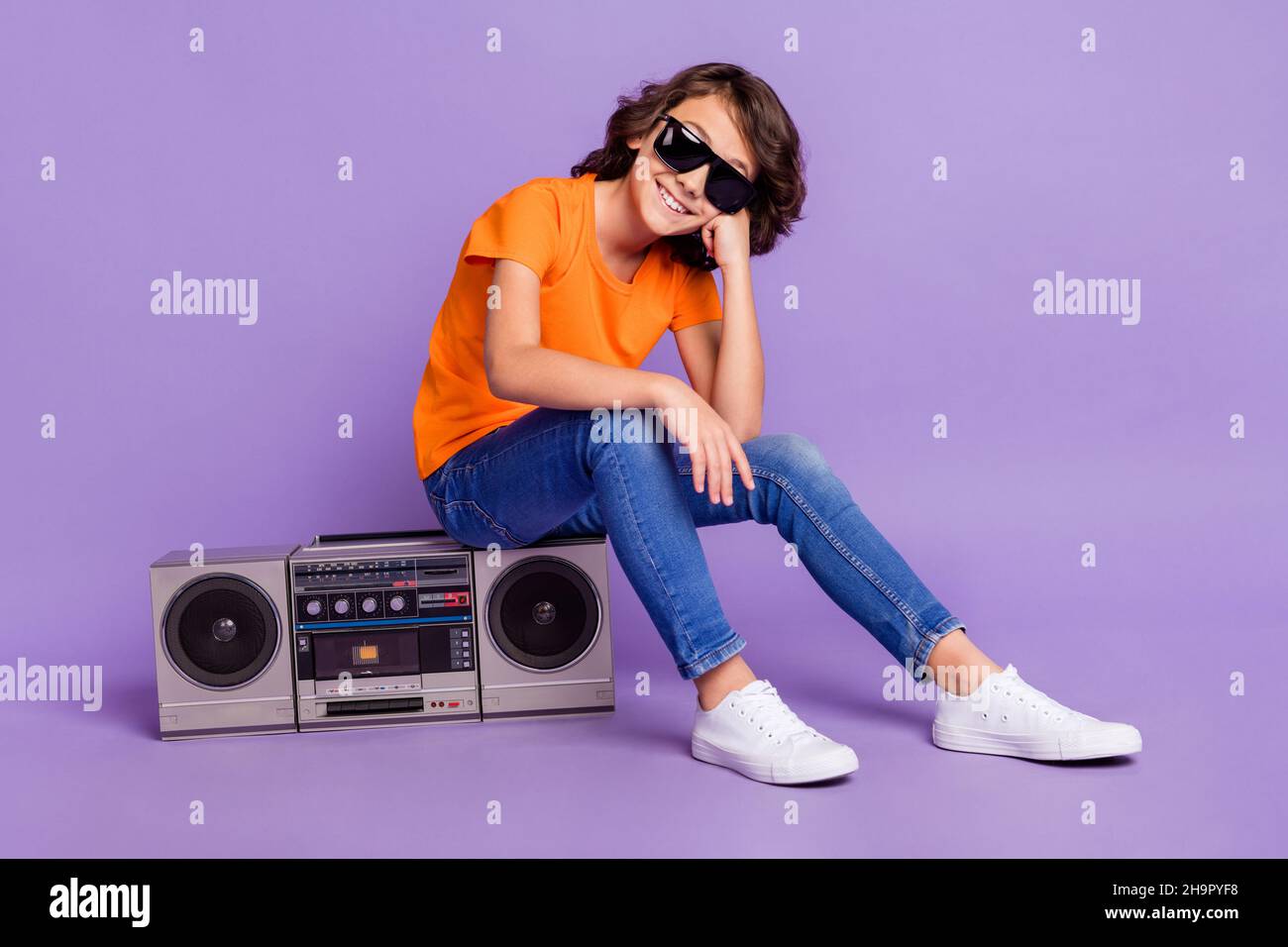 Full length body size photo small boy sitting on boom box smiling ...