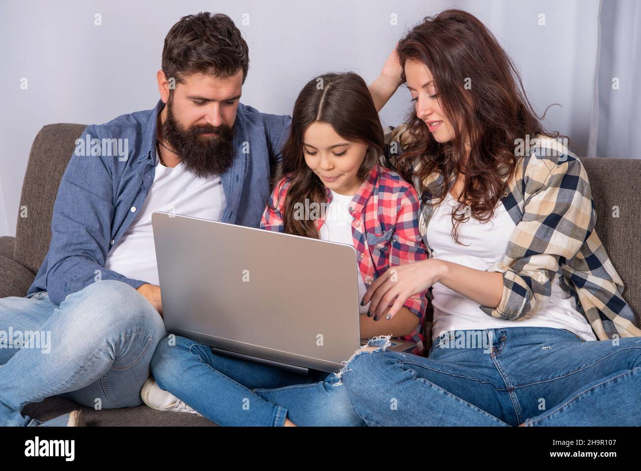 smiling mother father and daughter use computer, education Stock Photo ...