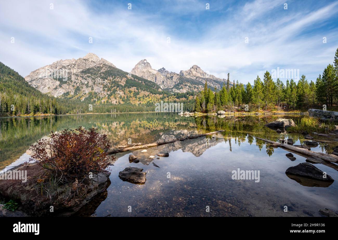 Reflection in Taggart Lake, view of the Teton Range, peaks Grand Teton and Teewinot Mountain ...