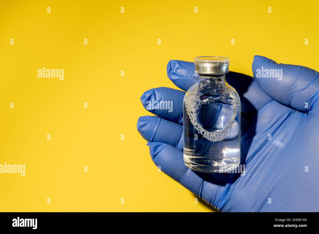 Doctor's hand holding an injectable vial with medicine - the concept of ...