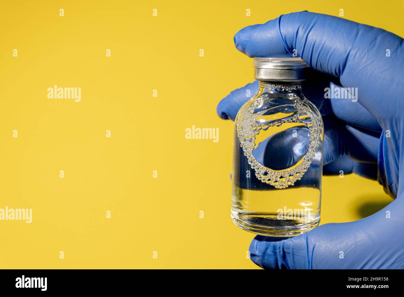 Doctor's hand holding an injectable vial with medicine - the concept of ...