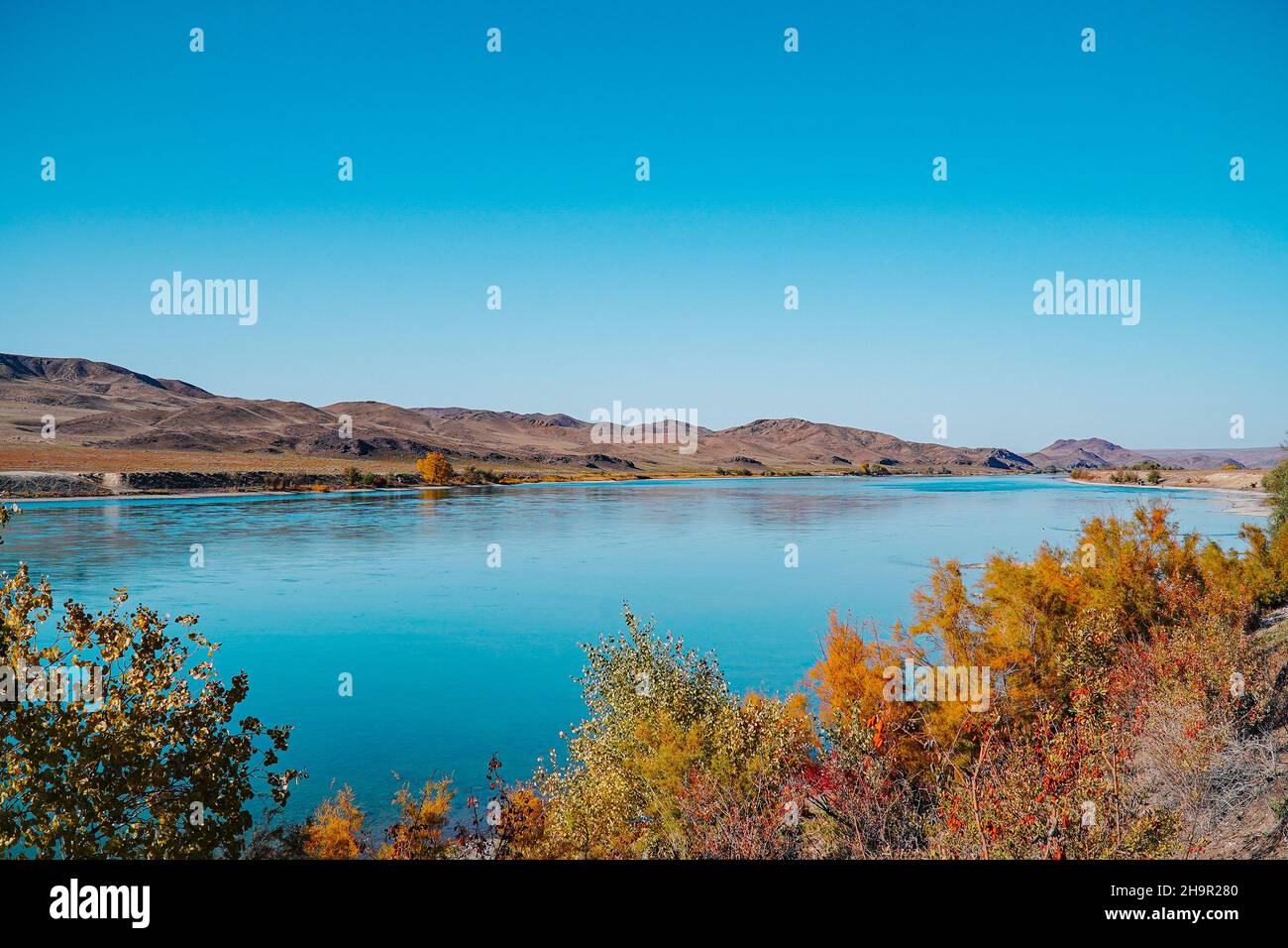 A beautiful autumn landscape of a blue river Stock Photo - Alamy