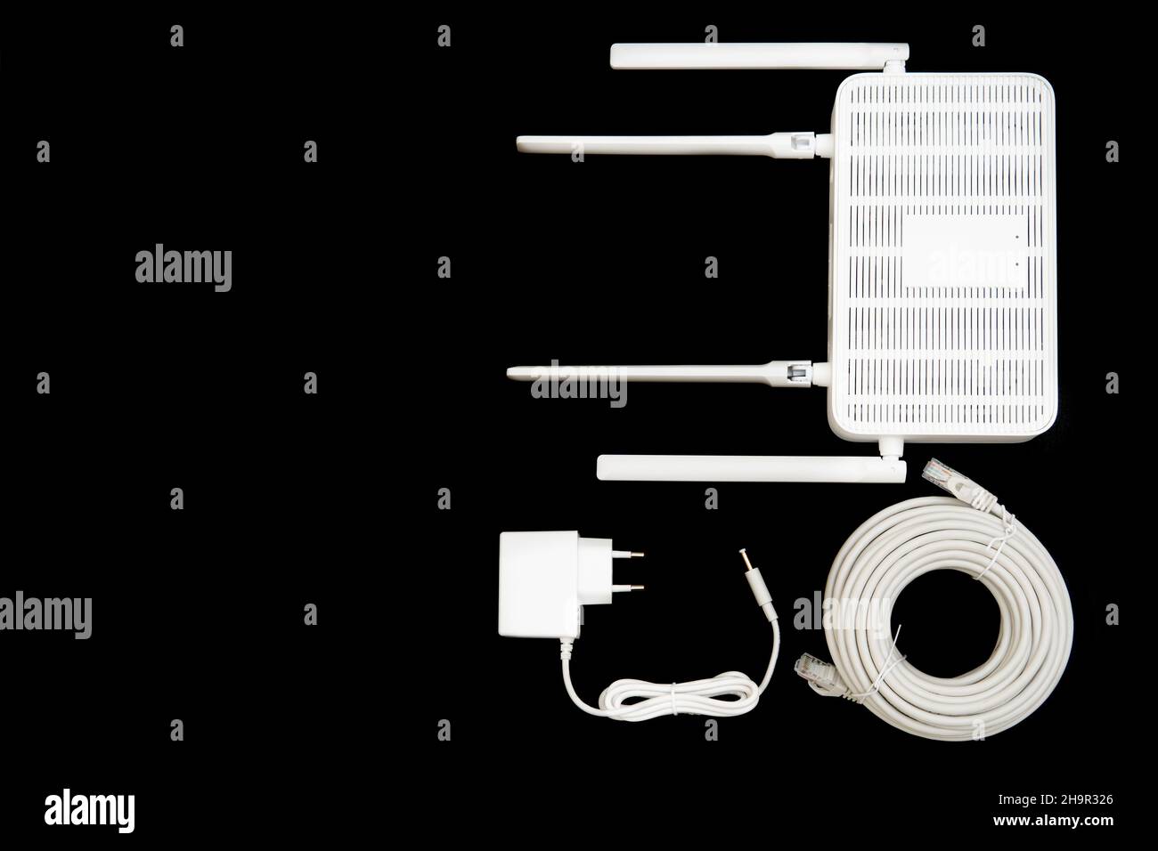 Top view of a dual band Wi-Fi 6 router with a power supply adapter and ...