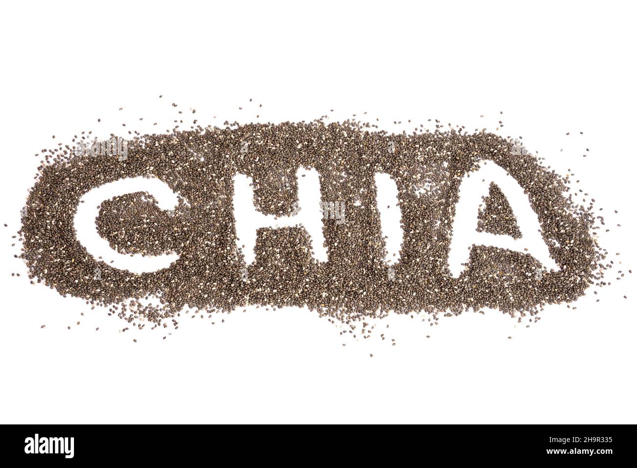 Word CHIA written on a scattered seeds background on a white table ...