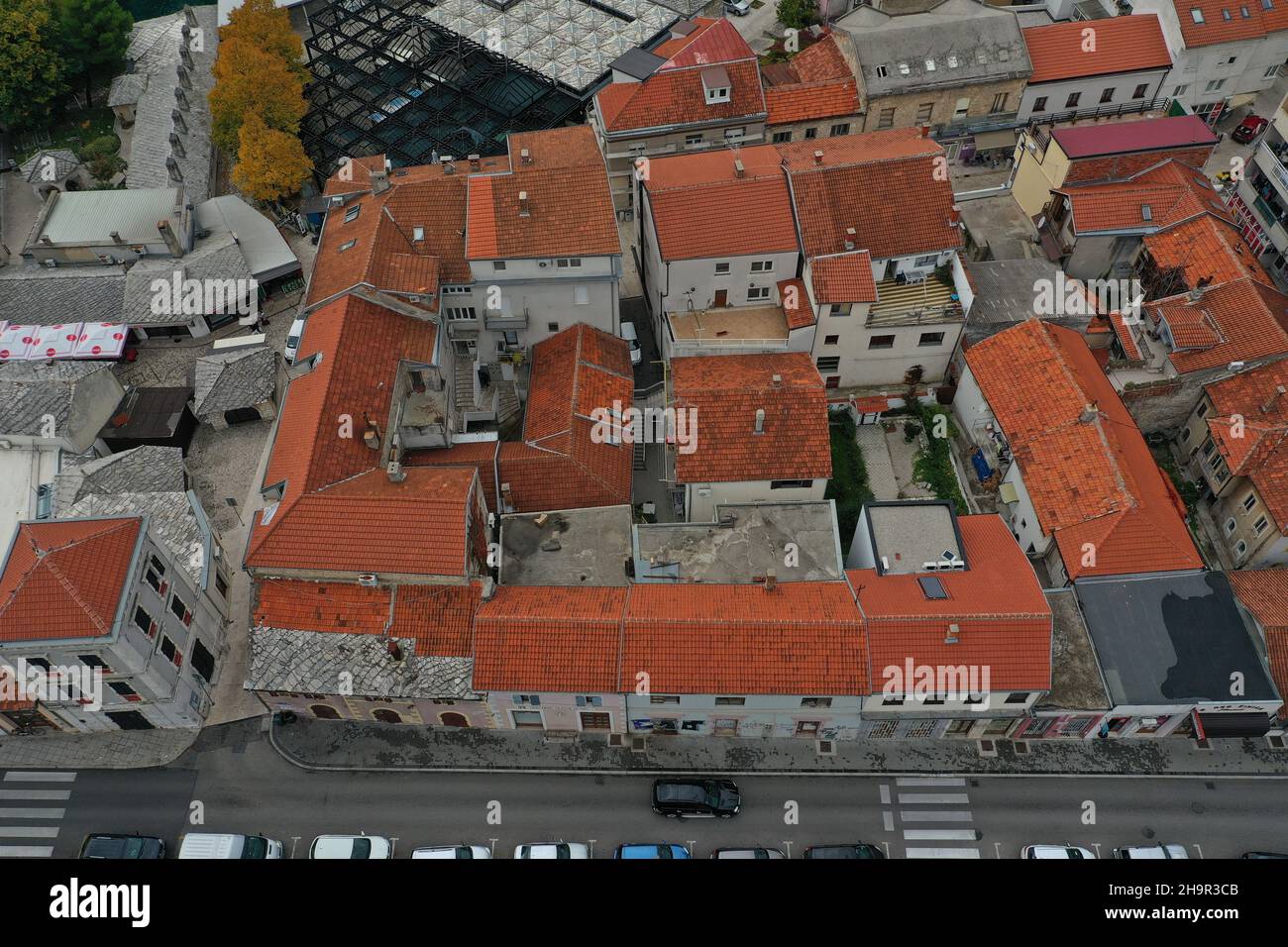Aerial view of buildings with tiled roofs and cars in the street Stock ...
