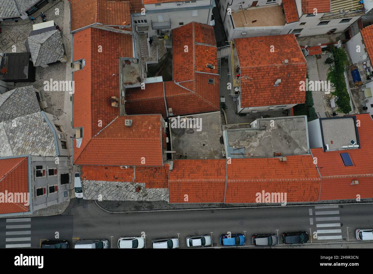 Aerial view of buildings with tiled roofs and cars in the street Stock ...