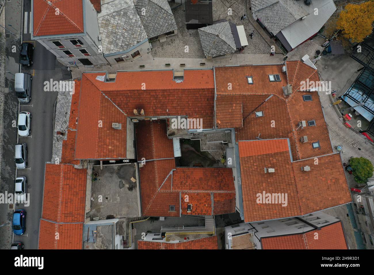 Aerial view of buildings with tiled roofs and cars in the street Stock ...