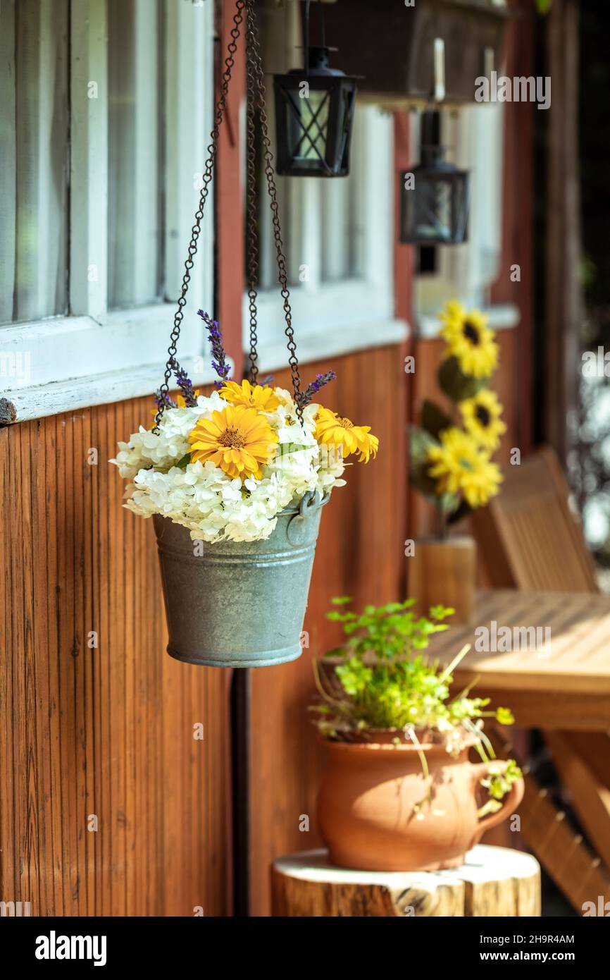 Flowers decoration in garden seating area at patio. White hydrangea ...