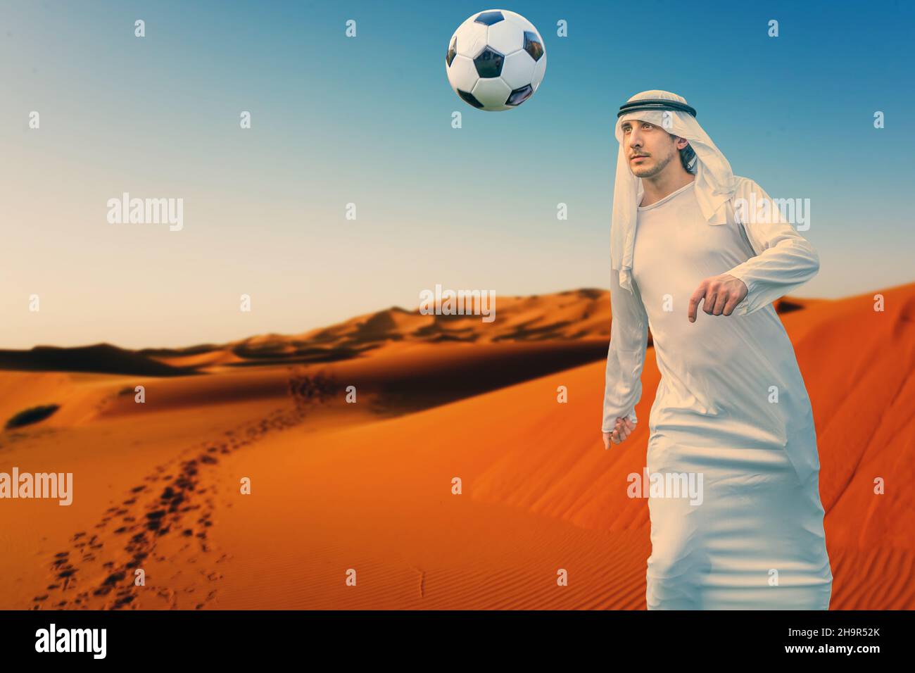 arab businessman playing with a soccer ball in the desert - Concept of ...