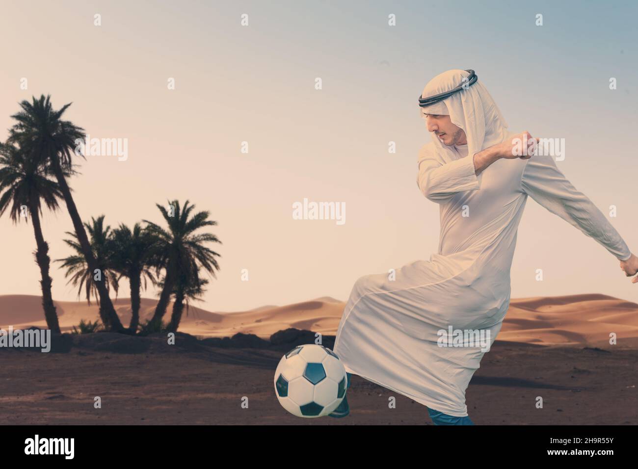 arab businessman playing with a soccer ball in the desert - Concept of ...