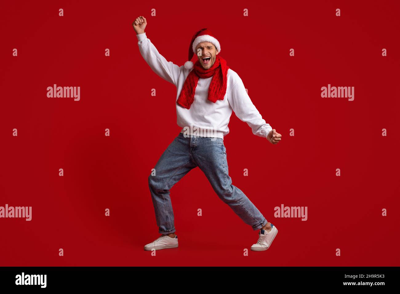Xmas Joy. Portrait Of Dancing Millennial Guy Wearing Santa Hat And ...
