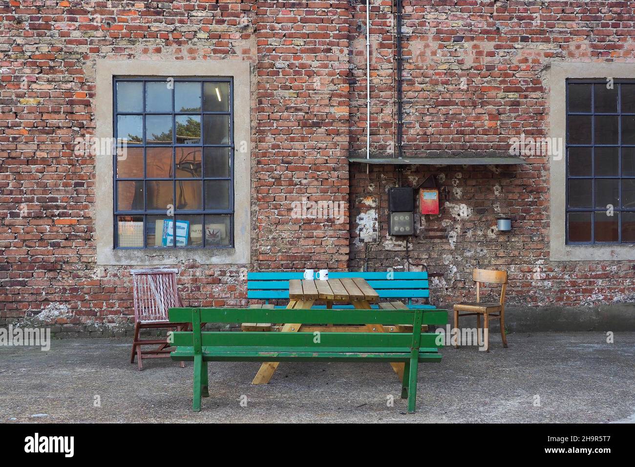 Factory hall on station premises with benches and table, breakfast ...
