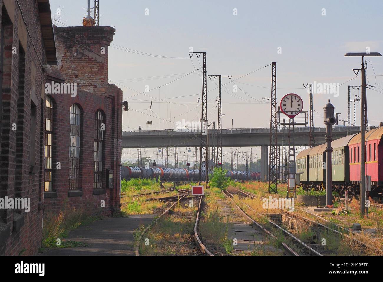 Station building with wagons, tracks and station clock, disused railway ...