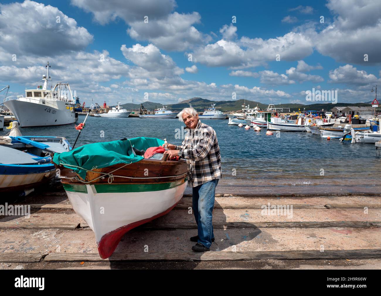 Sardinian fishermen in the harbour of Figari at Golfo Aranci, Sardinia ...