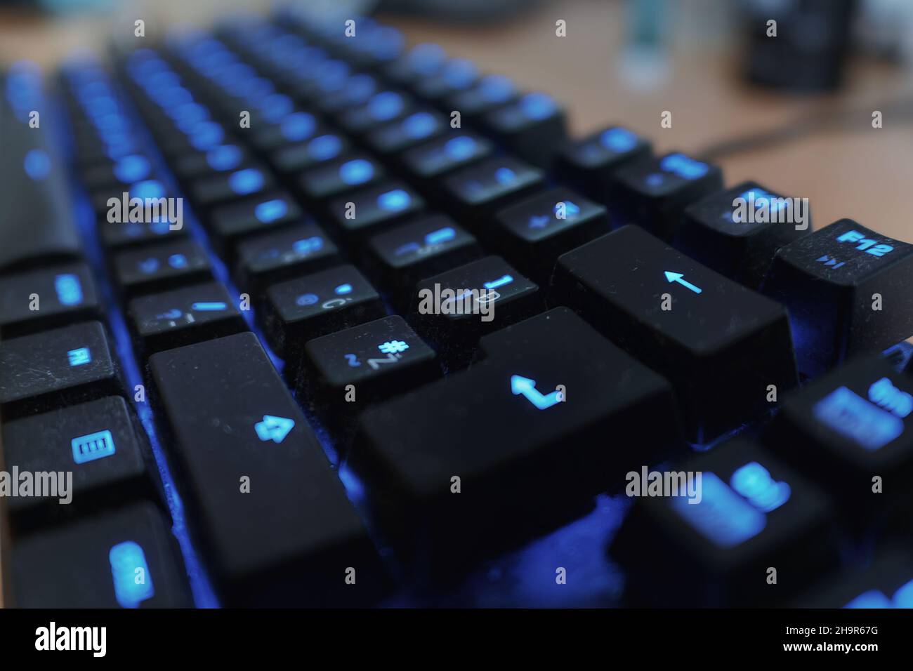 Closeup shot of a keyboard with blue lights Stock Photo - Alamy