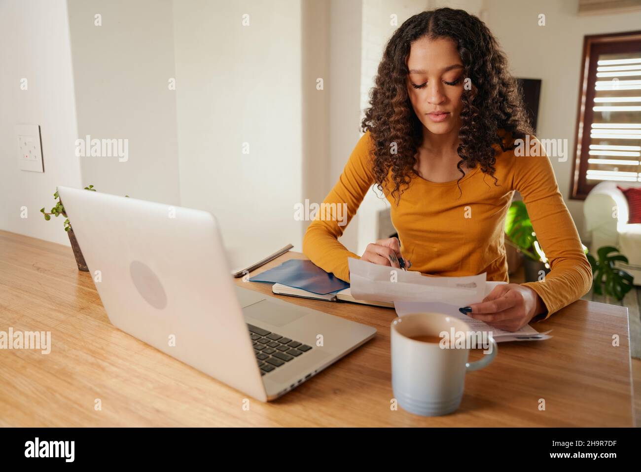 Multi-cultural female, Young professional remote working with laptop in ...