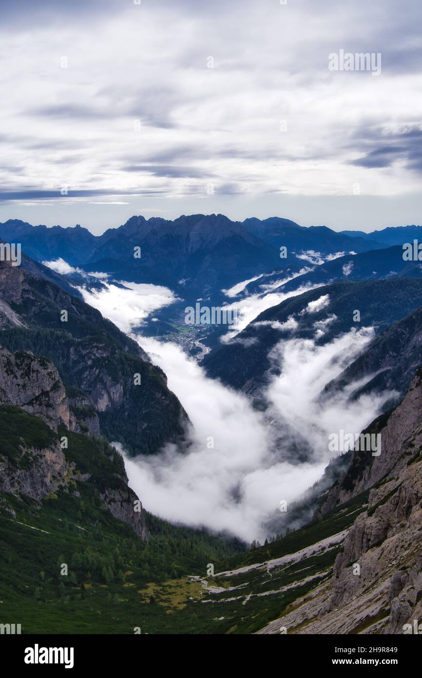 Mountain chain under the fog in Dolomites, Italy Stock Photo - Alamy