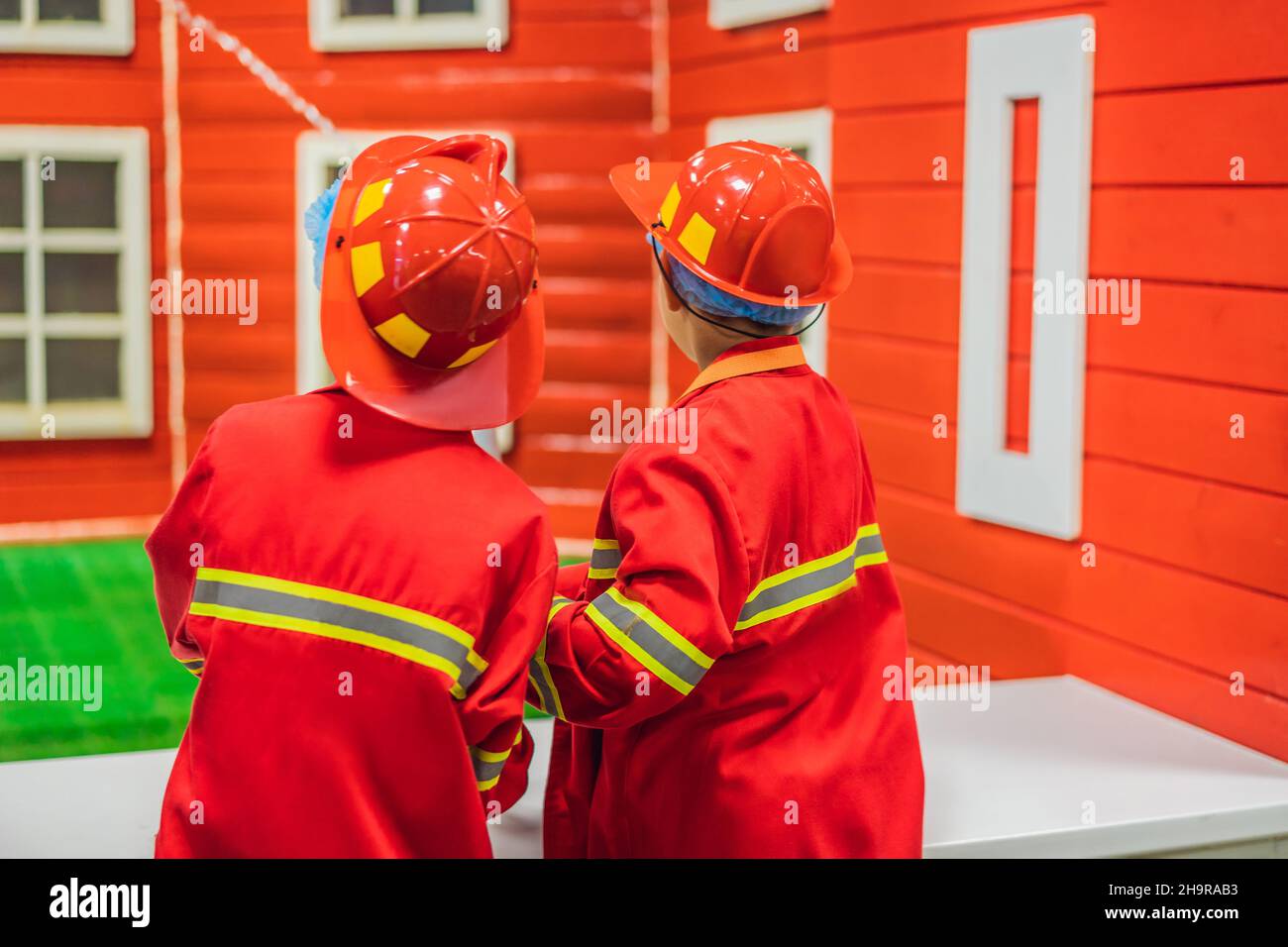 Children play firefighters, extinguish a toy fire Stock Photo - Alamy