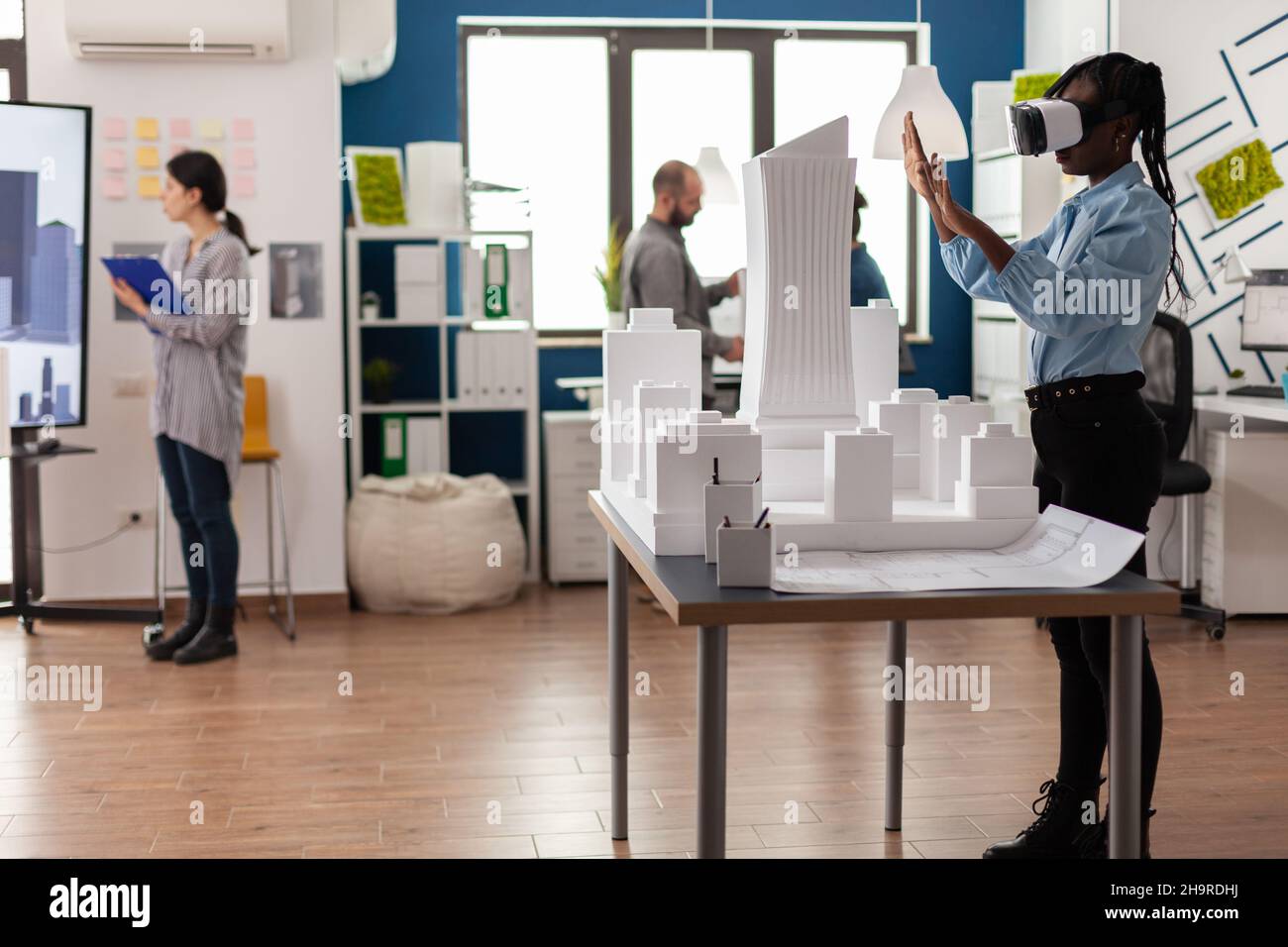 Architect standing in modern architectural office using virtual reality ...