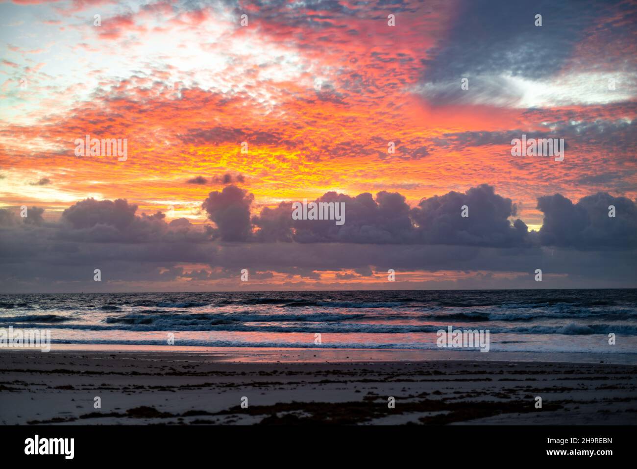 Mesmerizing view of multicolor sunset on the sea from the sandy beach ...