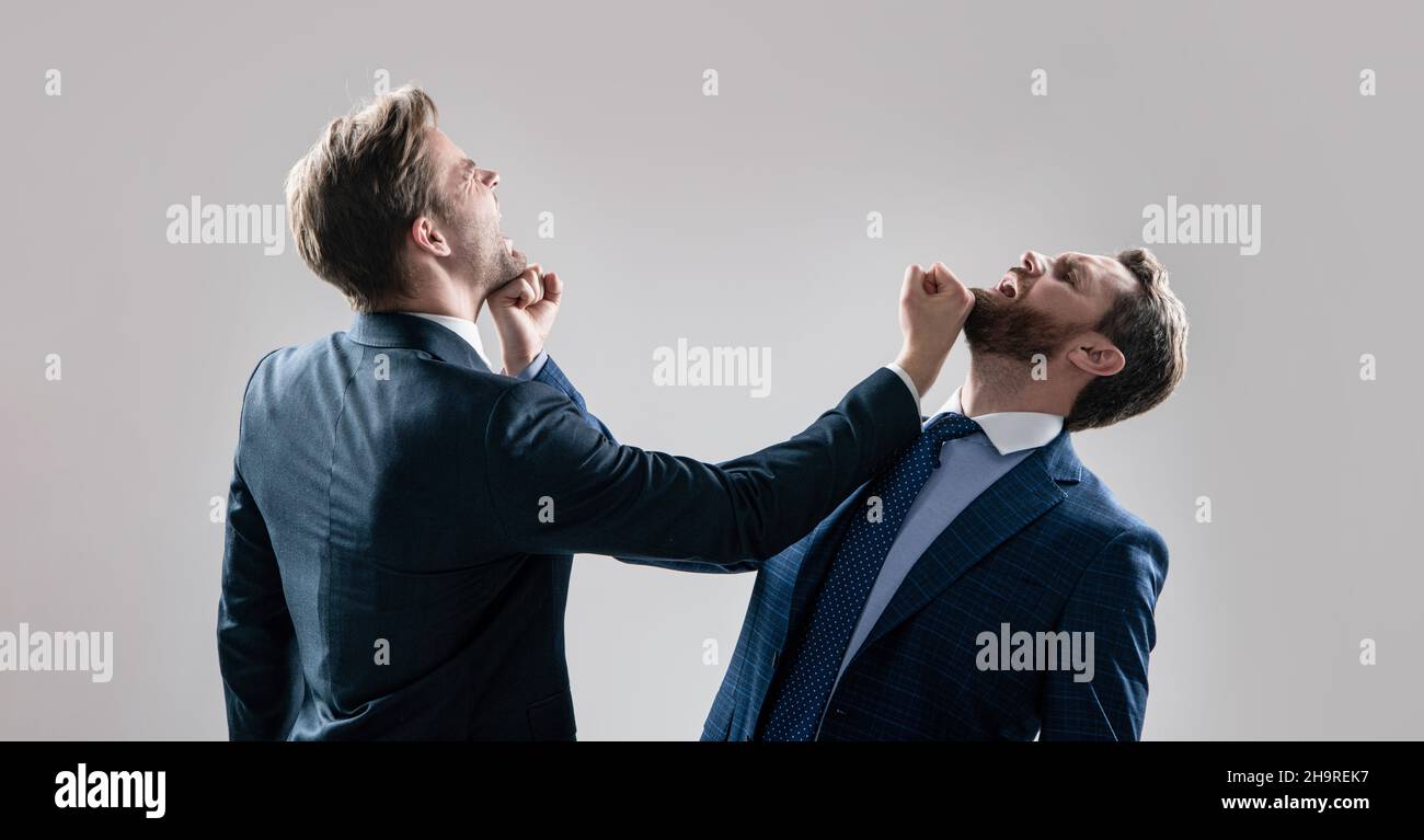fighting businesspeople. dissatisfied men. fist in face. colleagues ...
