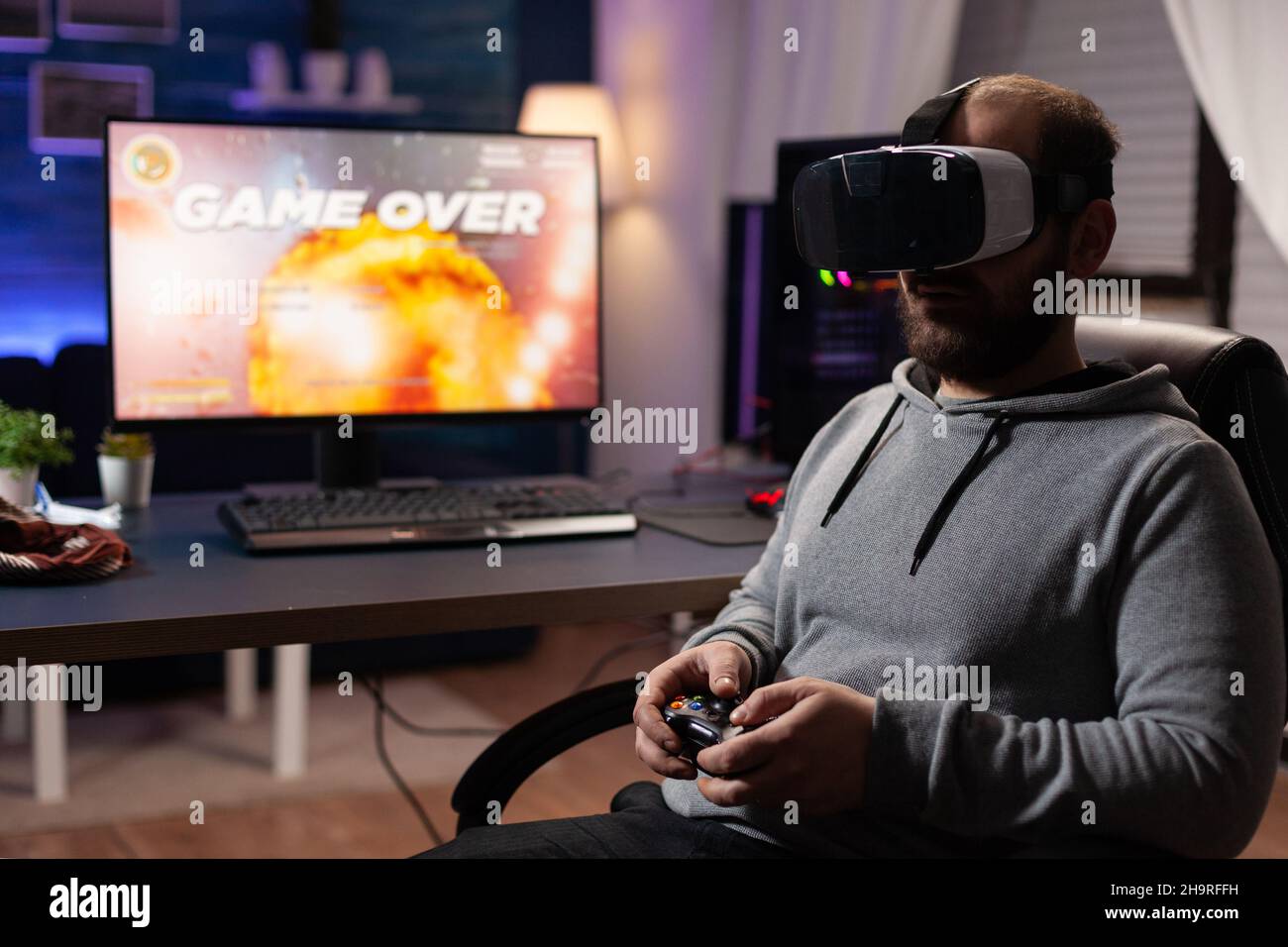 Man playing video games on computer using vr glasses. Gamer with ...