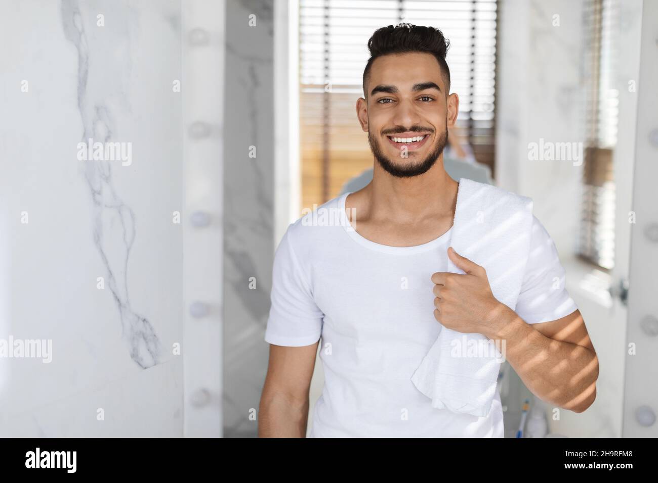 Handsome Young Arab Man With Towel On Shoulder Posing In Bathroom Stock ...