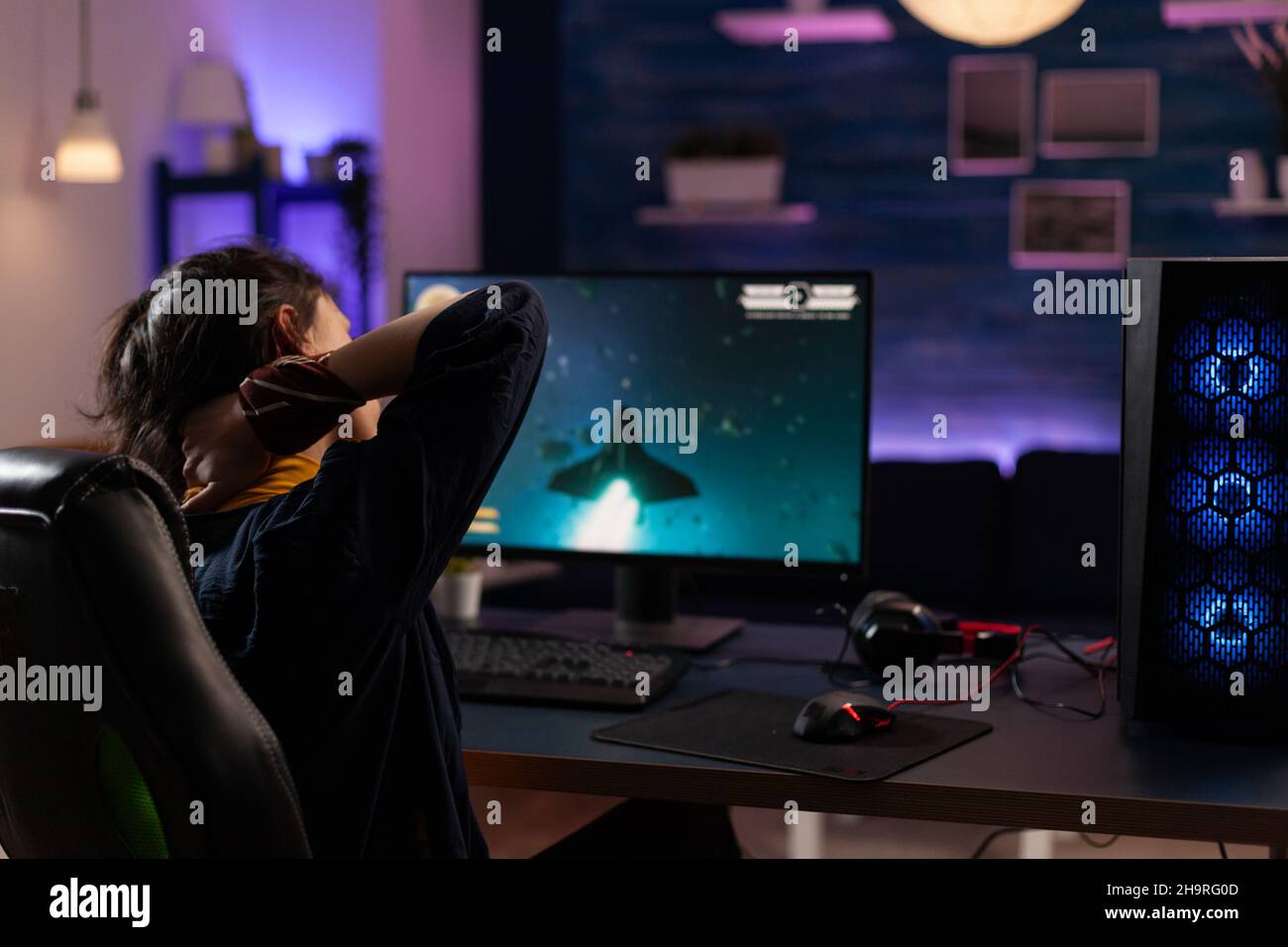 Person preparing to play video games on monitor. Woman using keyboard ...
