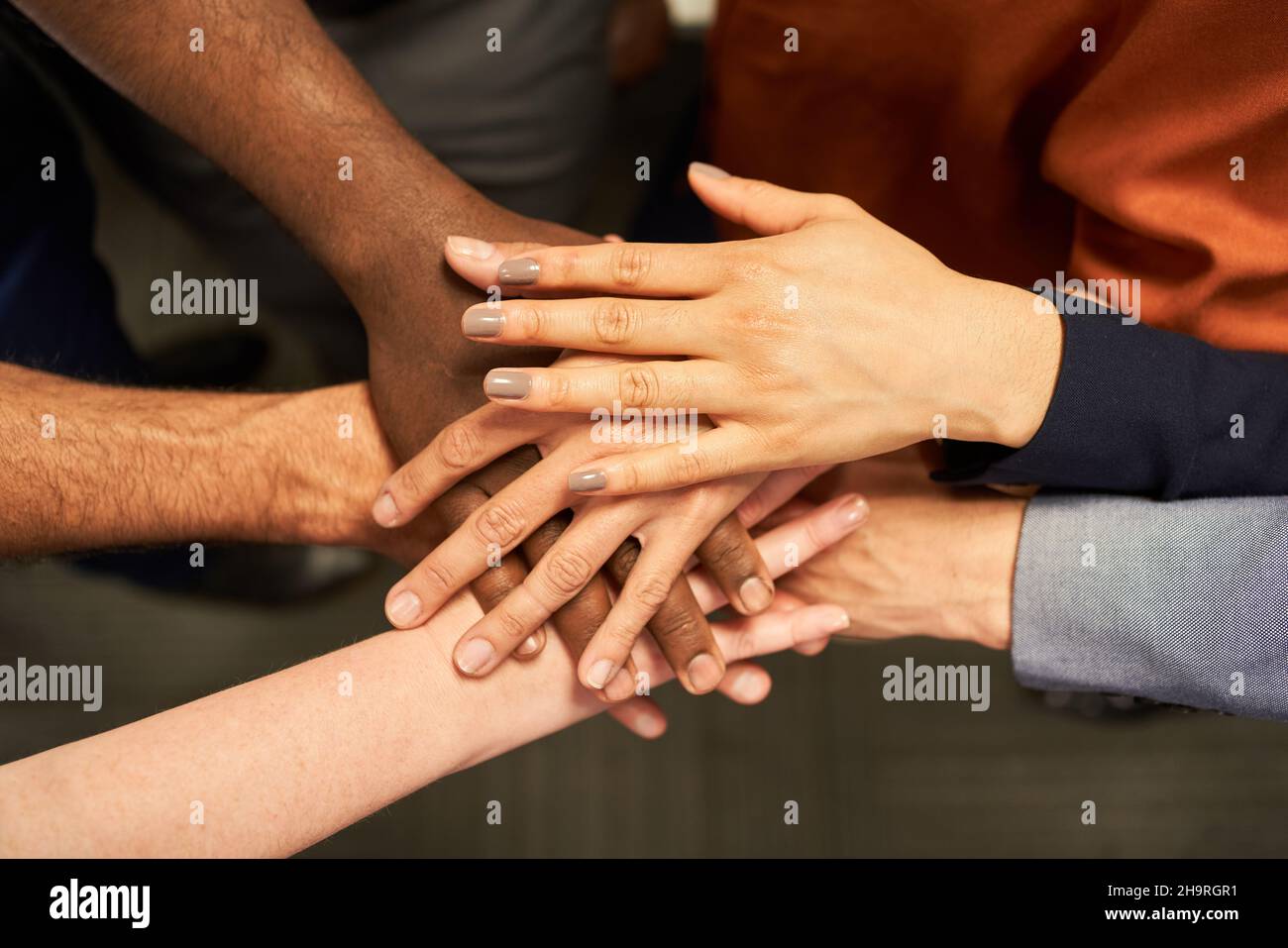 Business team people stacking hands as a symbol for network and team ...