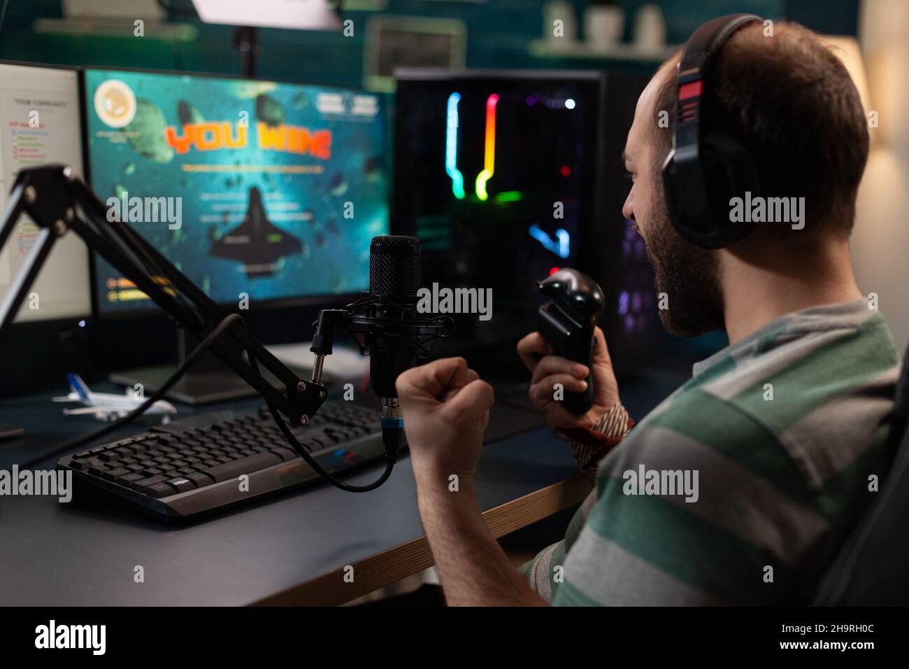 Streamer winning video games with joystick on computer. Man live ...
