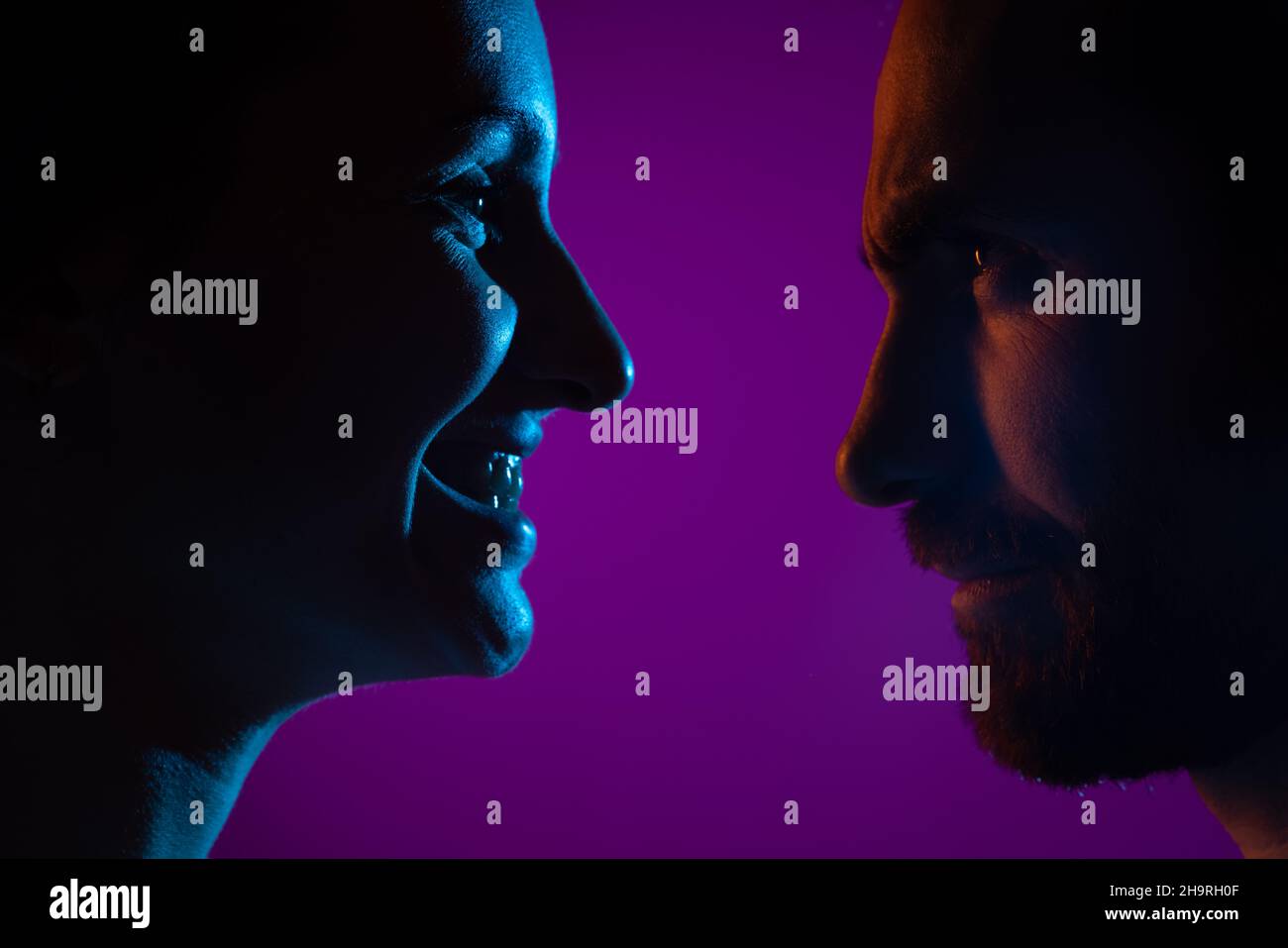 Close-up portrait of young couple standing face to face to each other ...