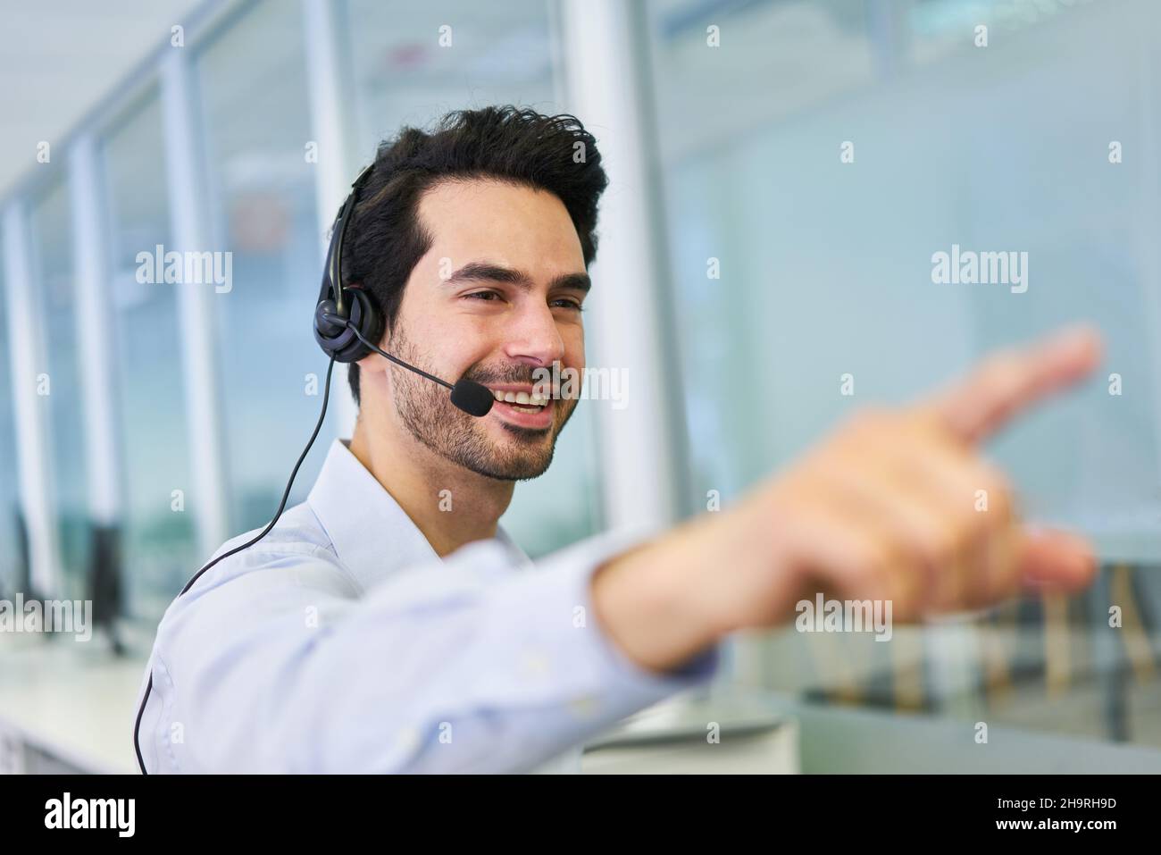 Successful start-up founder with a headset at a video conference or web ...