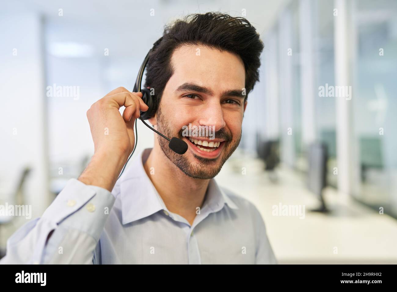 Young businessman as a customer service representative with headset ...