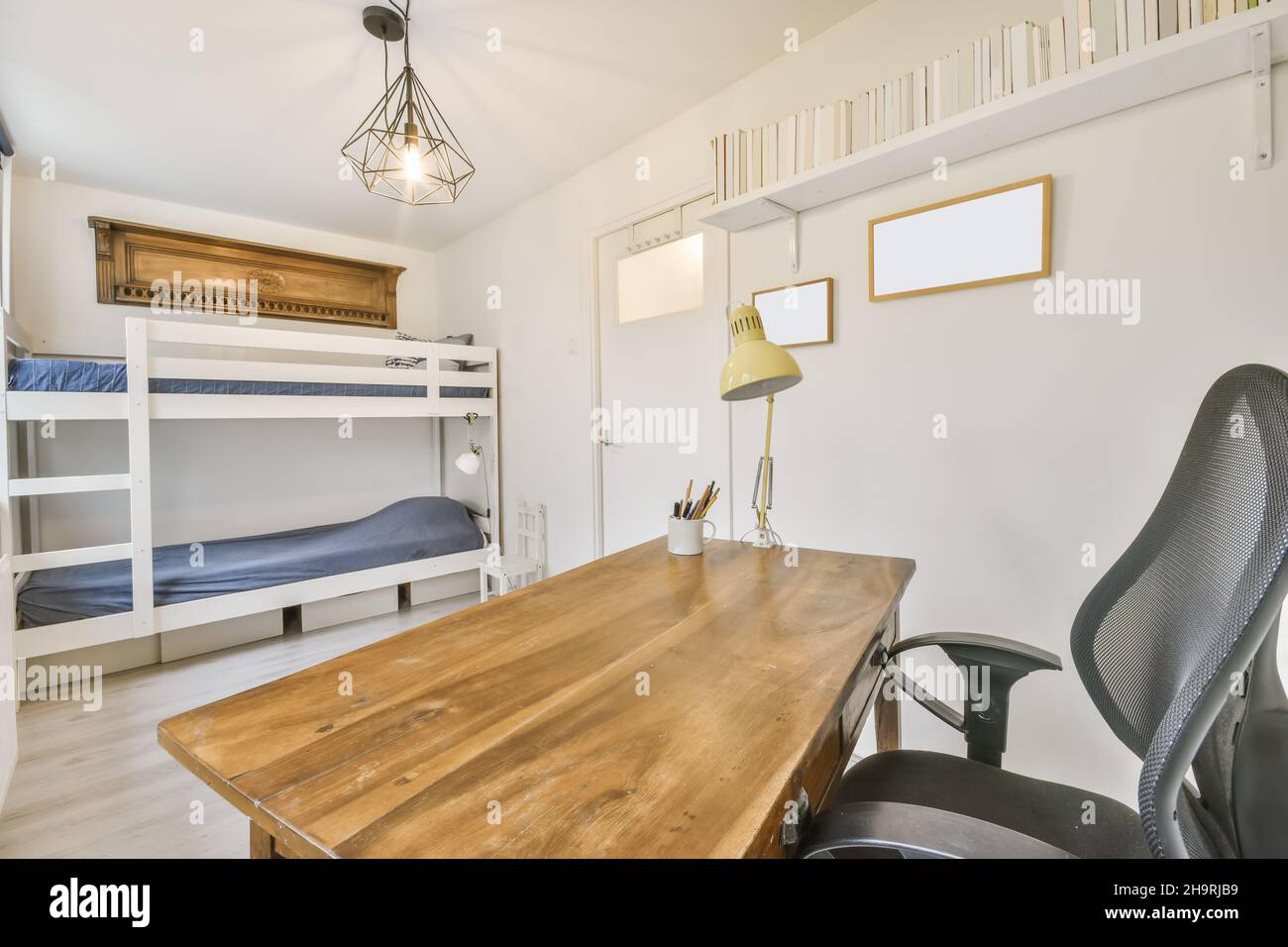 Cozy study area with wooden table and comfortable black chair Stock ...