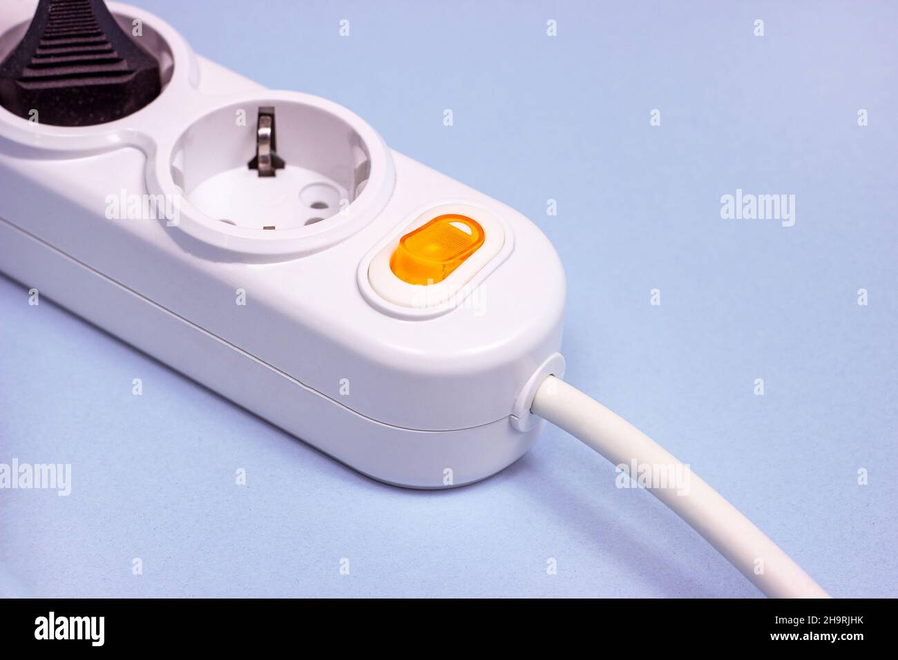 Triple socket white European power adapter with different wires at home ...