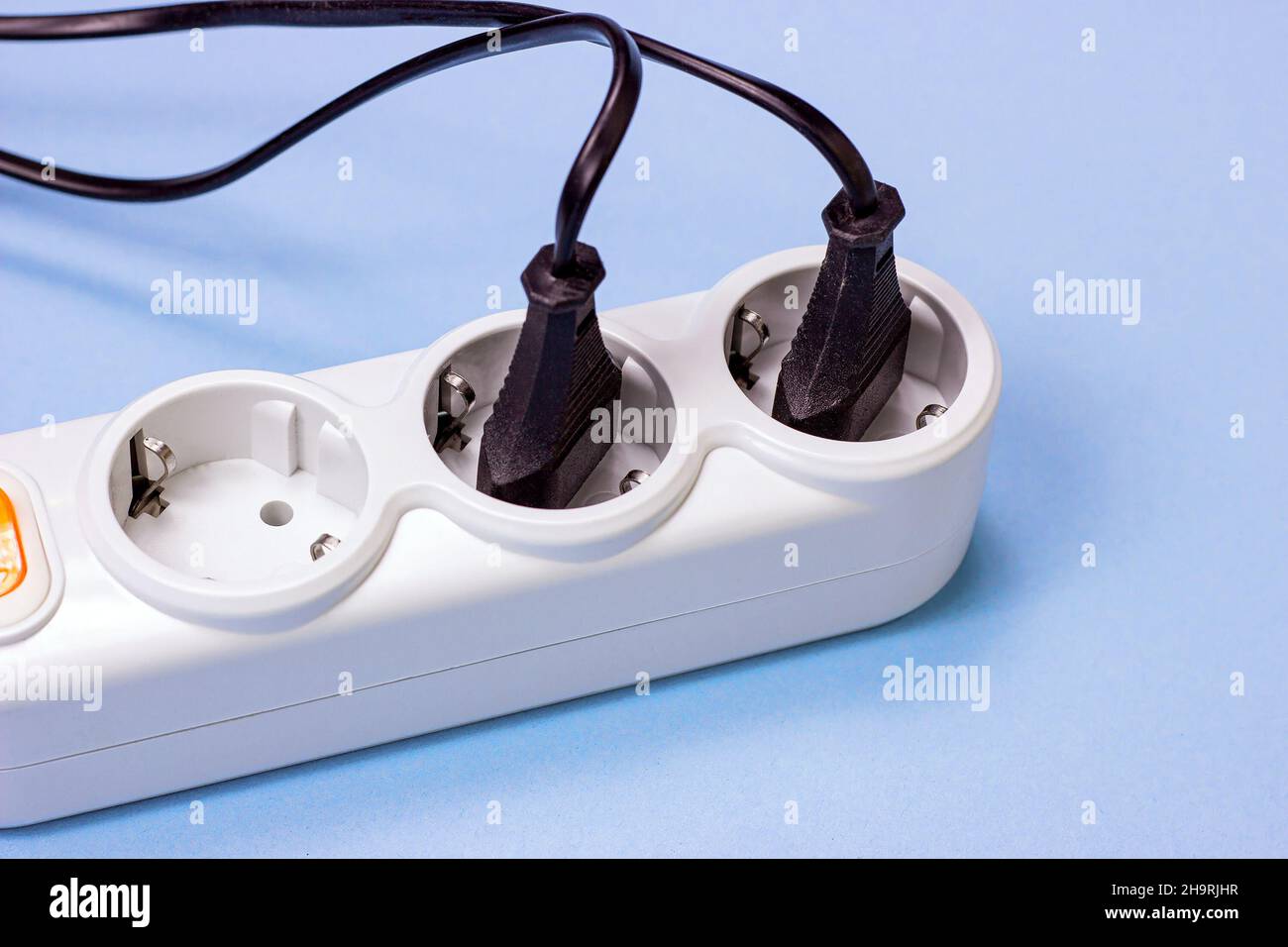 Triple socket white European power adapter with different wires at home ...
