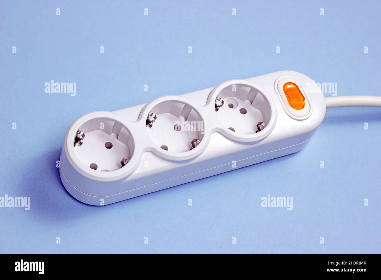 Triple socket white European power adapter with different wires at home ...